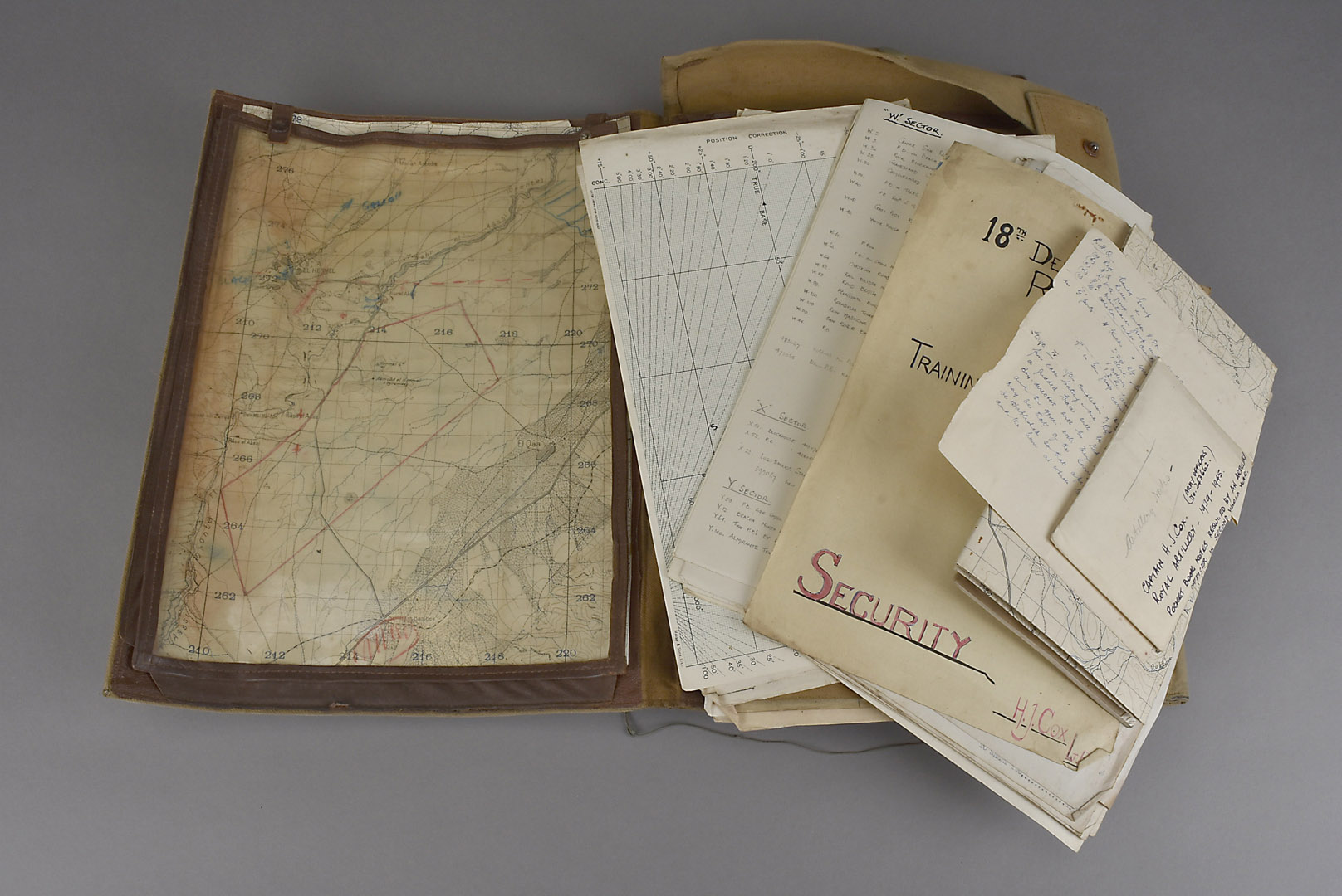 A WWII document holder, containing various documents, including a map ...