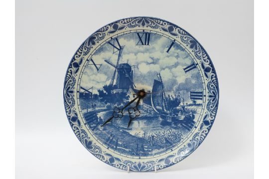 A blue and white Delft wall clock (diameter 33cm)