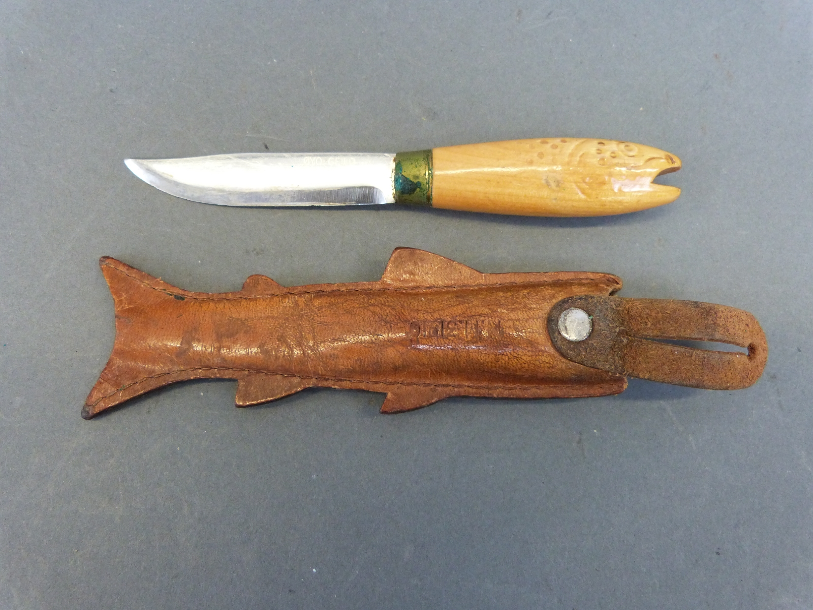 A carved figural fish knife marked OYO Geilo Rustfri to blade and ...