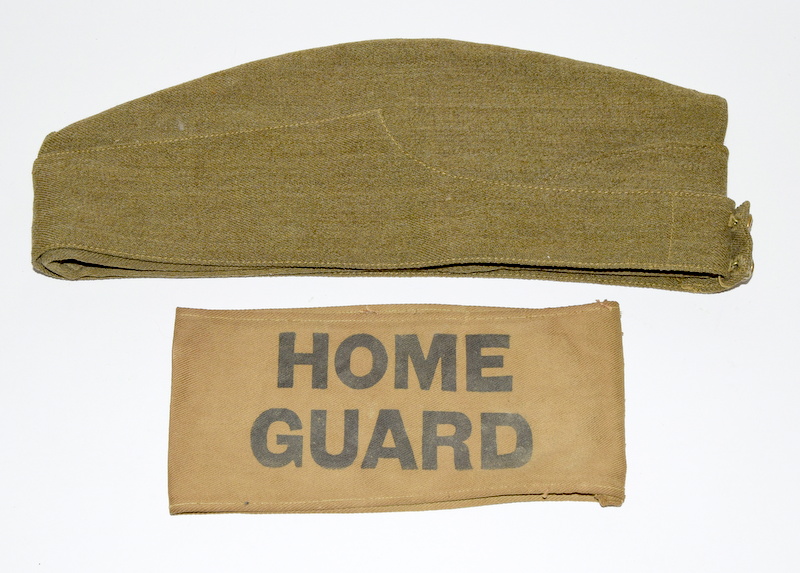A WW2 Home Guard arm band and a 1940 dated British army side cap