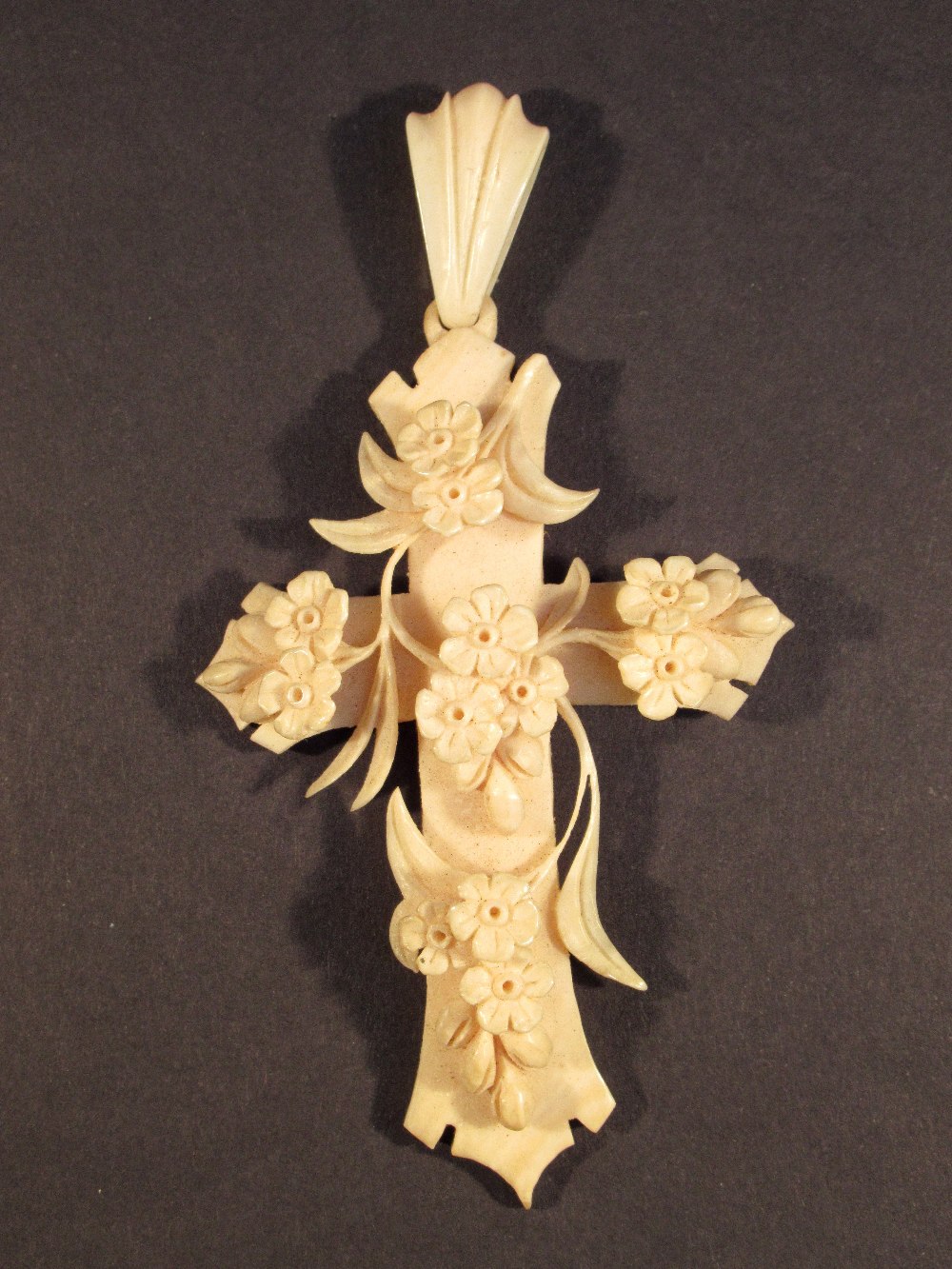 A VICTORIAN CARVED IVORY CROSS PENDANT WITH RAISED FLORAL AND FOLIATE ...