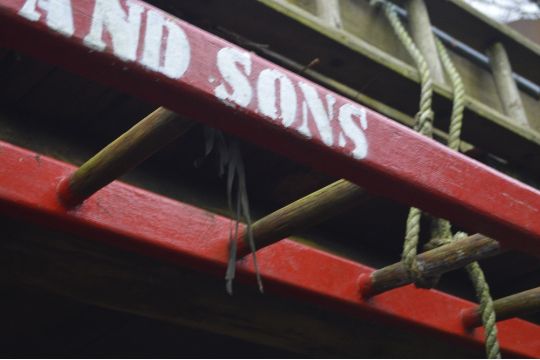 An iconic red painted wooden steeplejack ladder bearing the name 'Fred ...