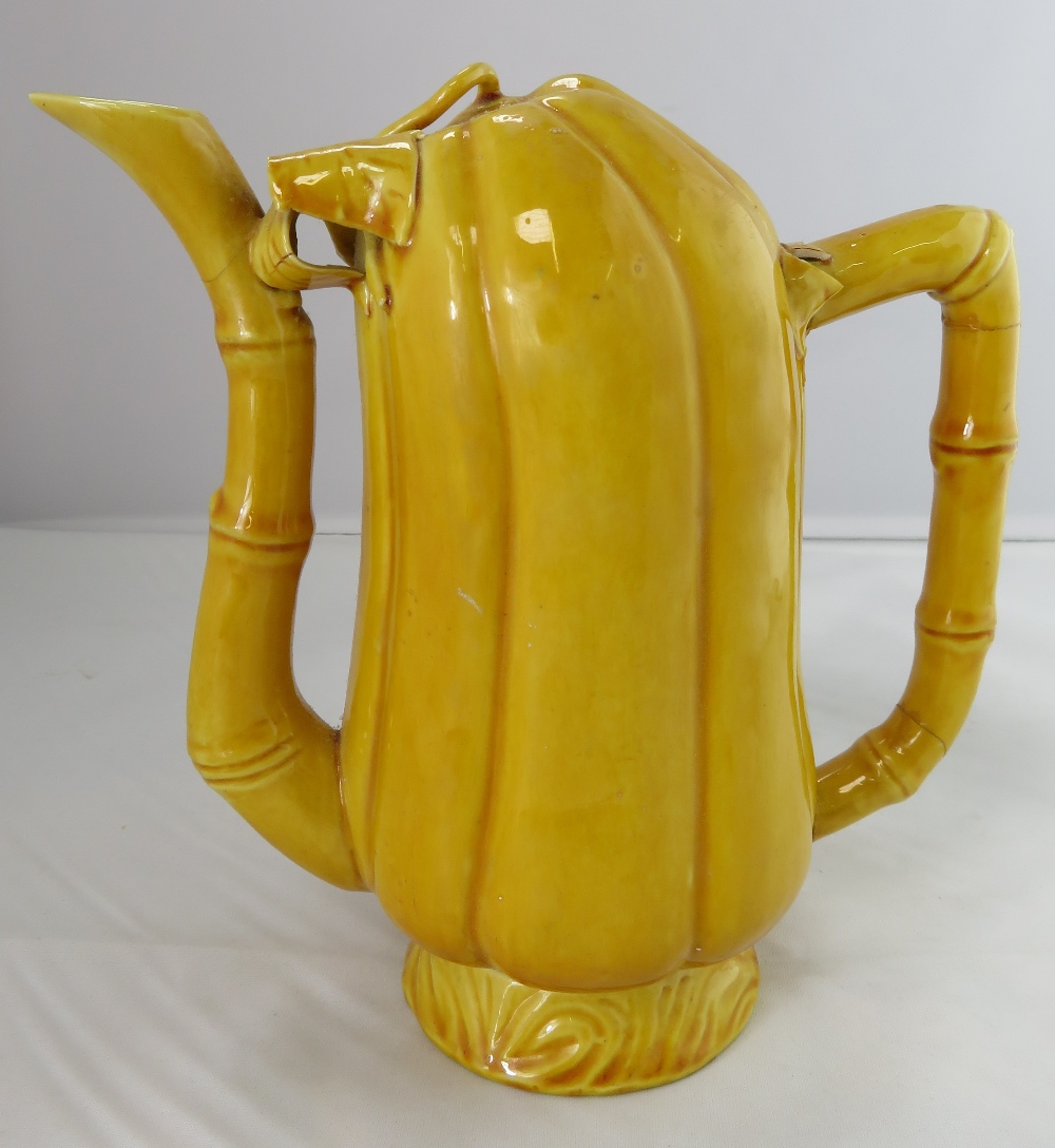 A Chinese yellow ground teapot, with bamboo style handle and spout, 16 ...