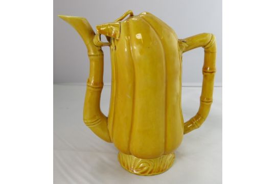 A Chinese yellow ground teapot, with bamboo style handle and spout, 16 ...