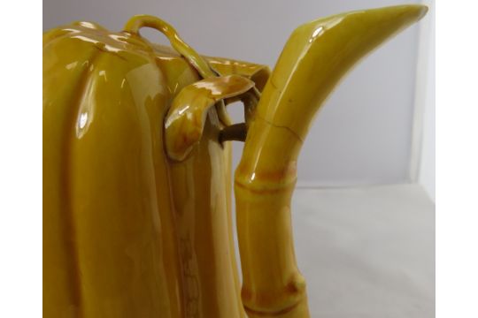 A Chinese yellow ground teapot, with bamboo style handle and spout, 16 ...