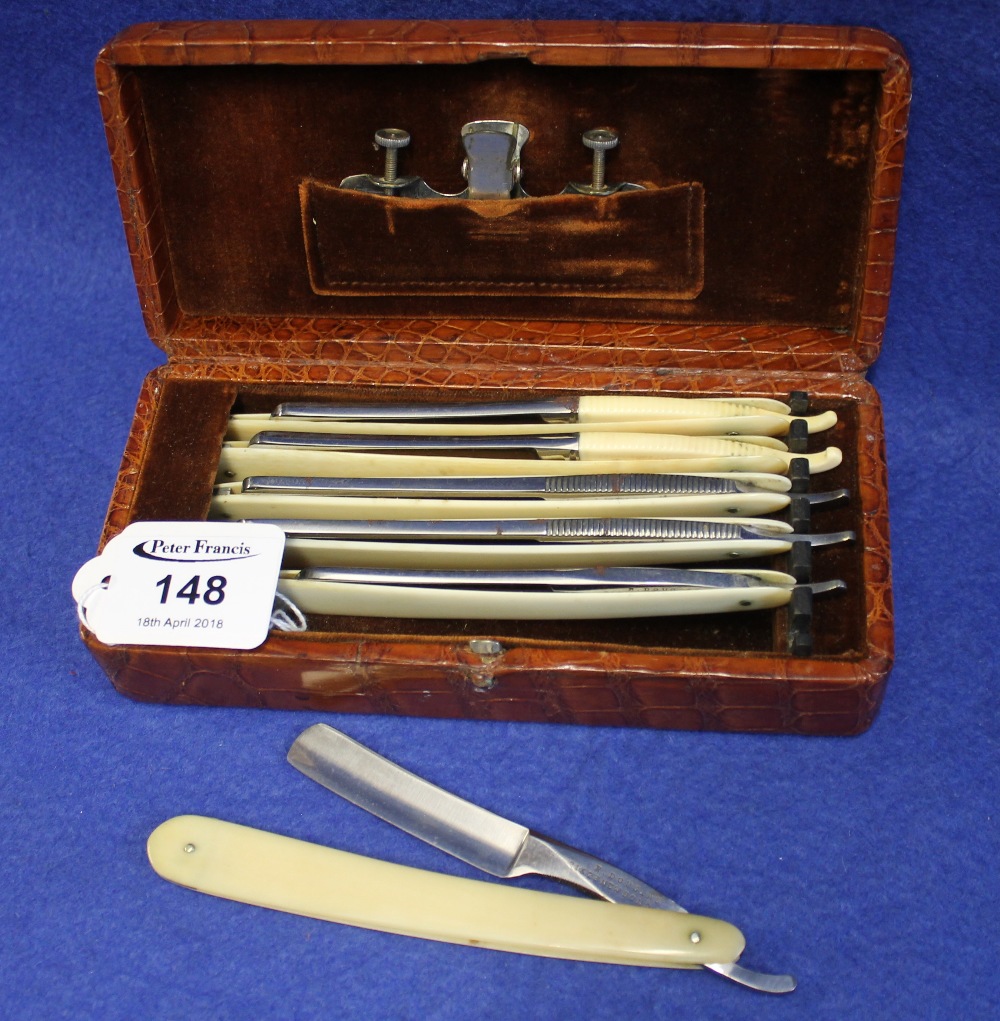 Cased set of ivory cut throat razors in fitted crocodile skin case. (B ...