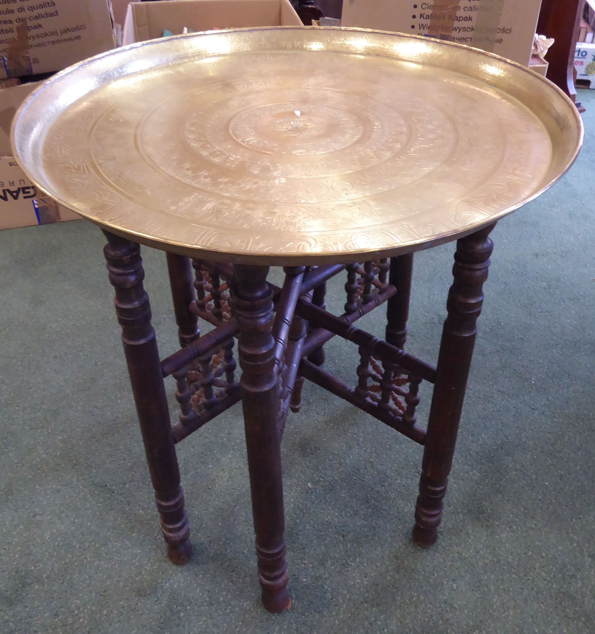 A Cairene engraved brass circular Tray on a folding table stand. 23 ...