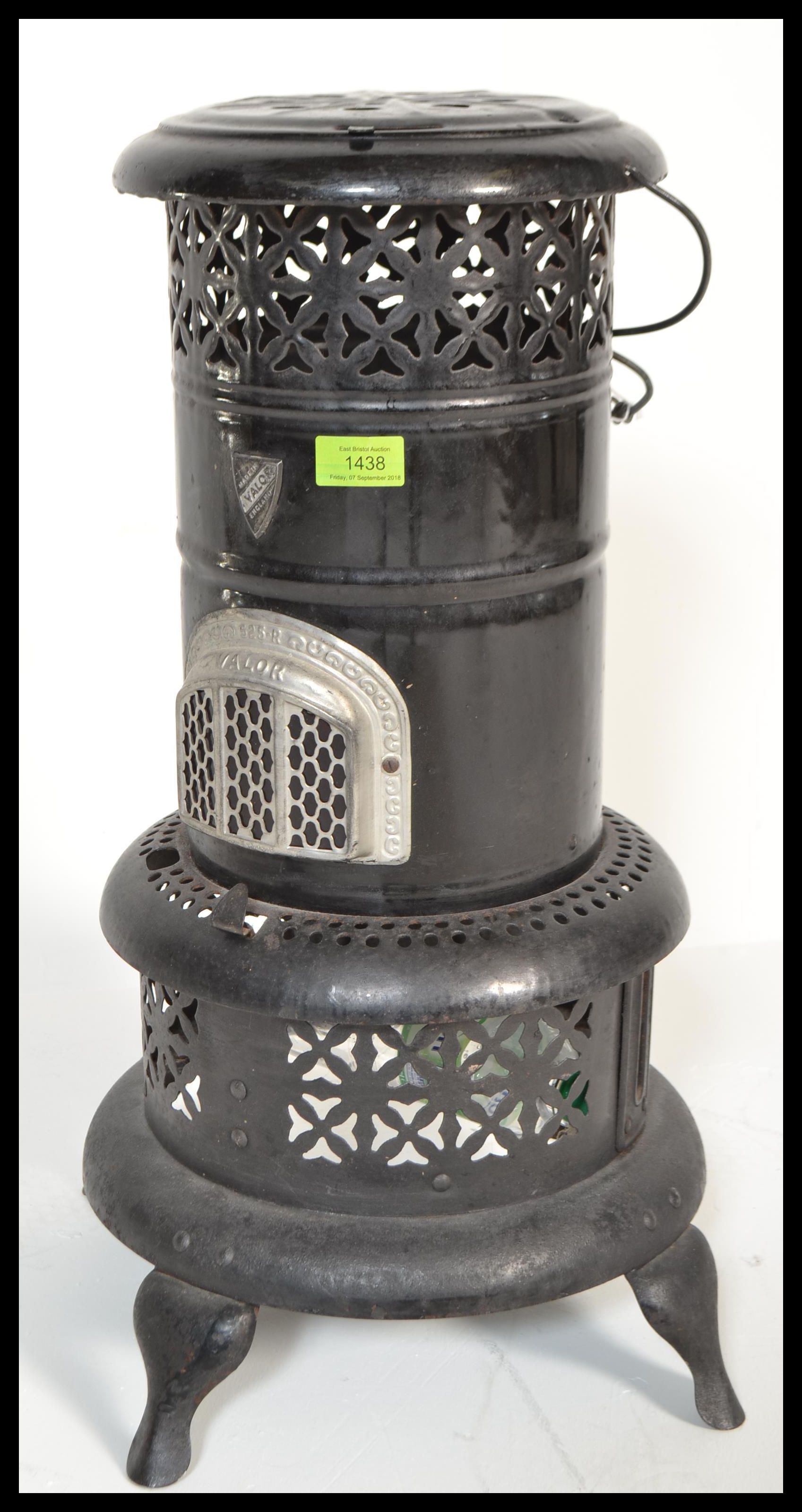 A vintage early 20th century Valor stove having a pierced design with ...