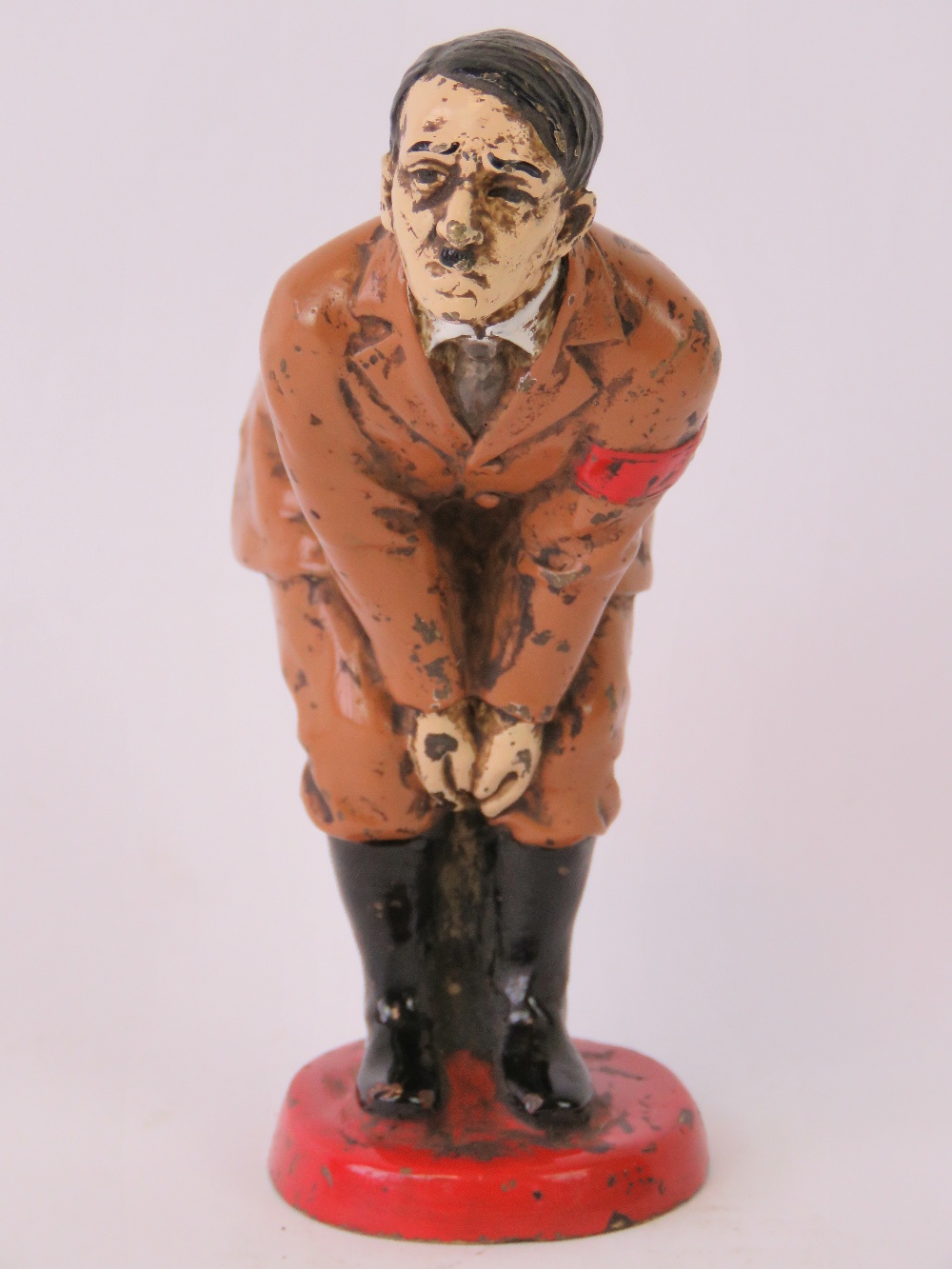 A novelty pin cushion in the form of Adolf Hitler, enamel on brass ...