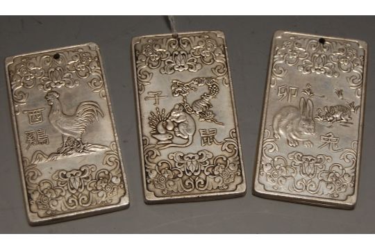 A set of three Chinese white metal trade tokens each of rectangular ...
