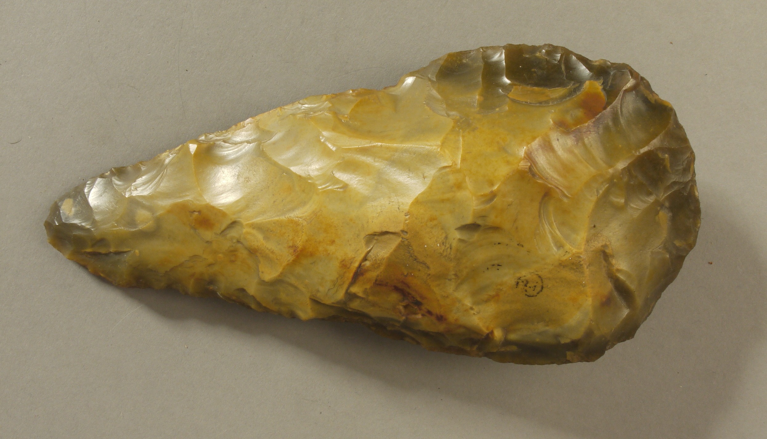 A GOOD NEOLITHIC FLINT AXE HEAD of knapped tapered ovoid form, 19.5cm ...