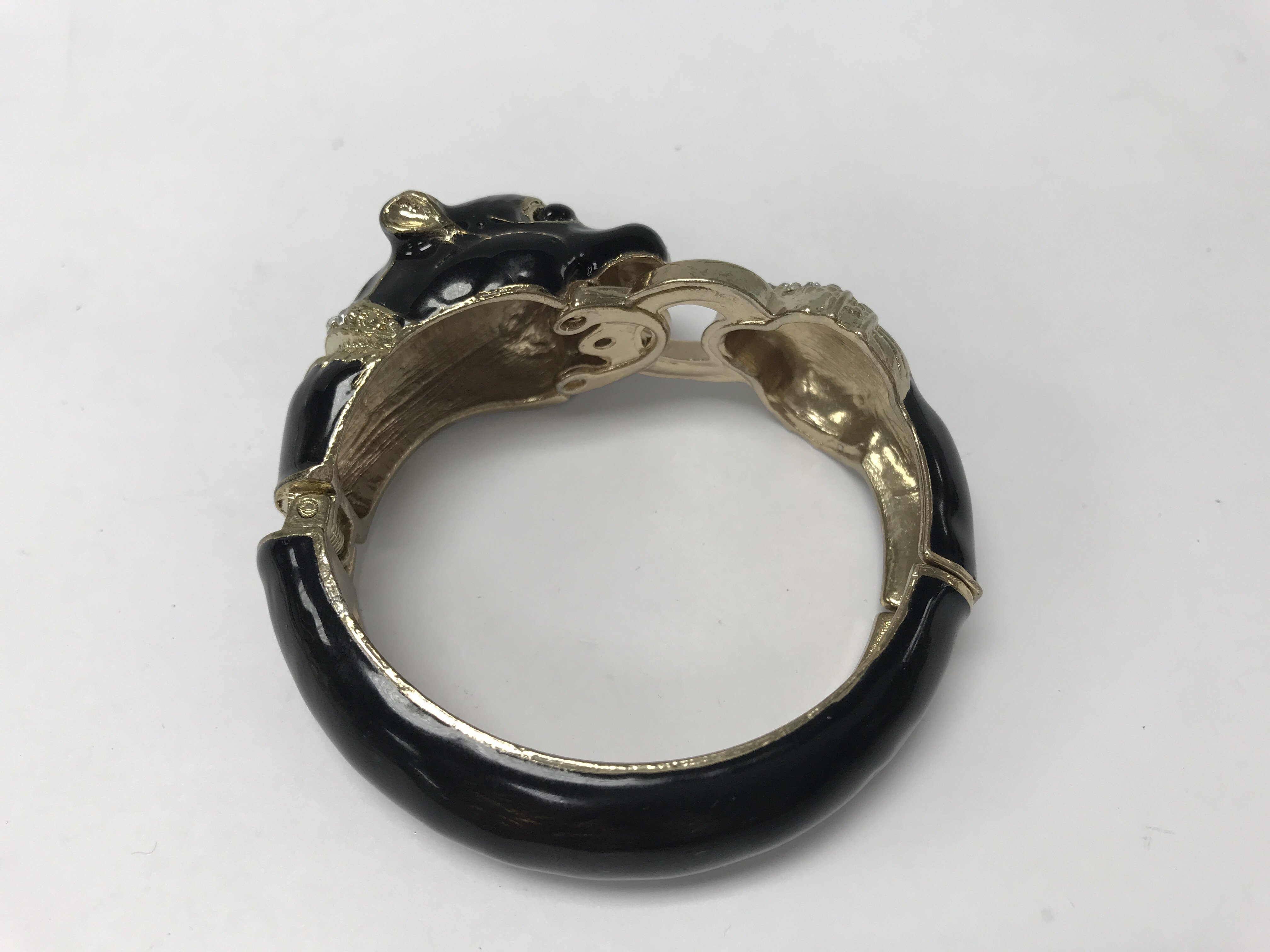 A metal Panther bracelet.