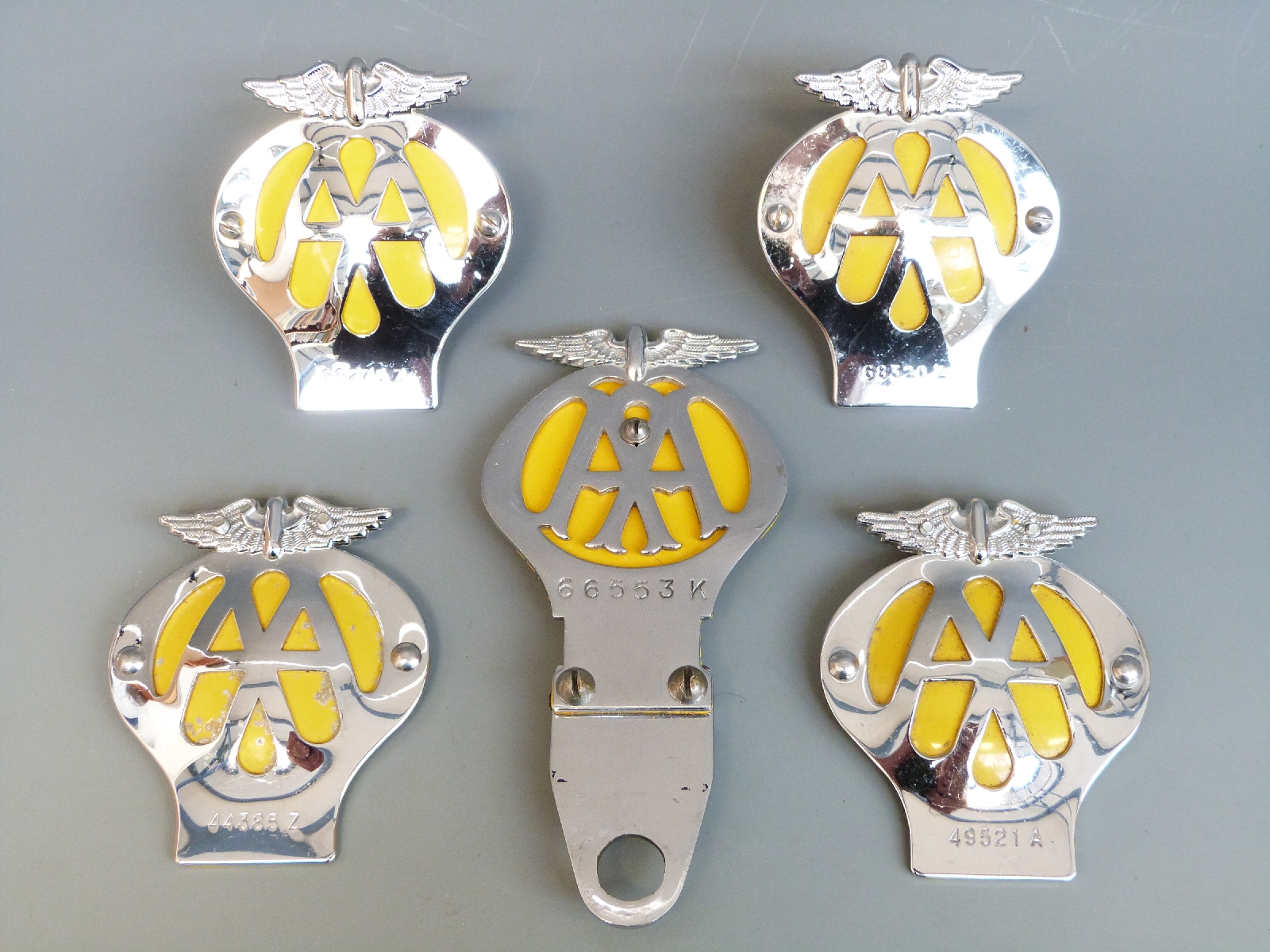 Five AA motorcycle badges, one earlier flat design marked 66553k