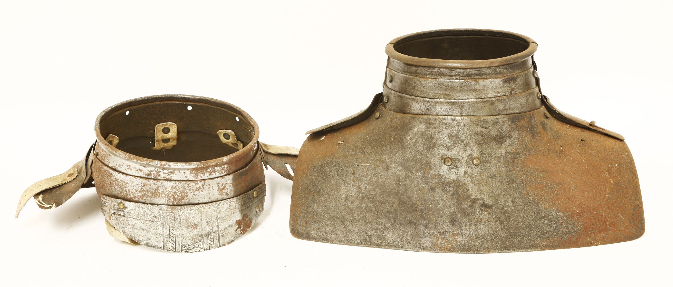 Two gorgets,16th century, one with etched decoration, the other plain ...
