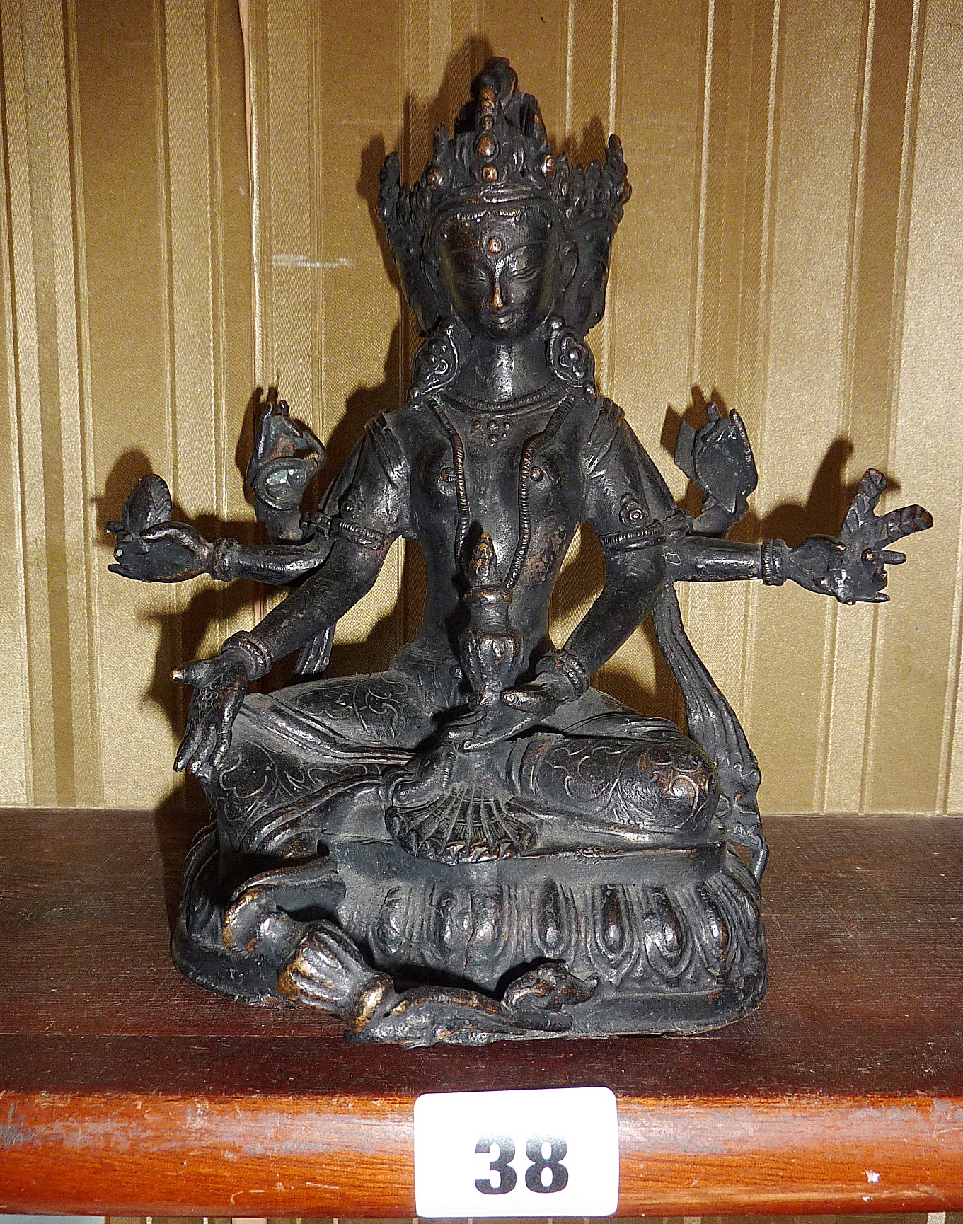 Indian bronze Shiva with three faces and multiple arms, approx 18cm high