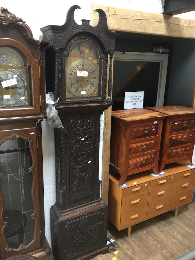 A THOMAS RAMSBOTTOM 8 DAY CARVED OAK LONGCASE CLOCK WITH BRASS DIAL