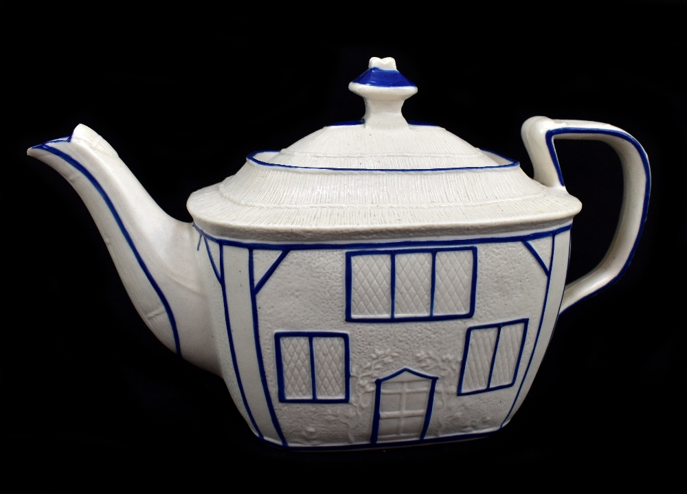 CASTLEFORD; a circa 1790 creamware teapot modelled as a cottage with ...