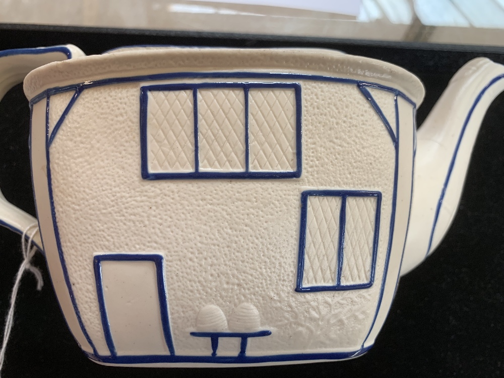 CASTLEFORD; a circa 1790 creamware teapot modelled as a cottage with ...