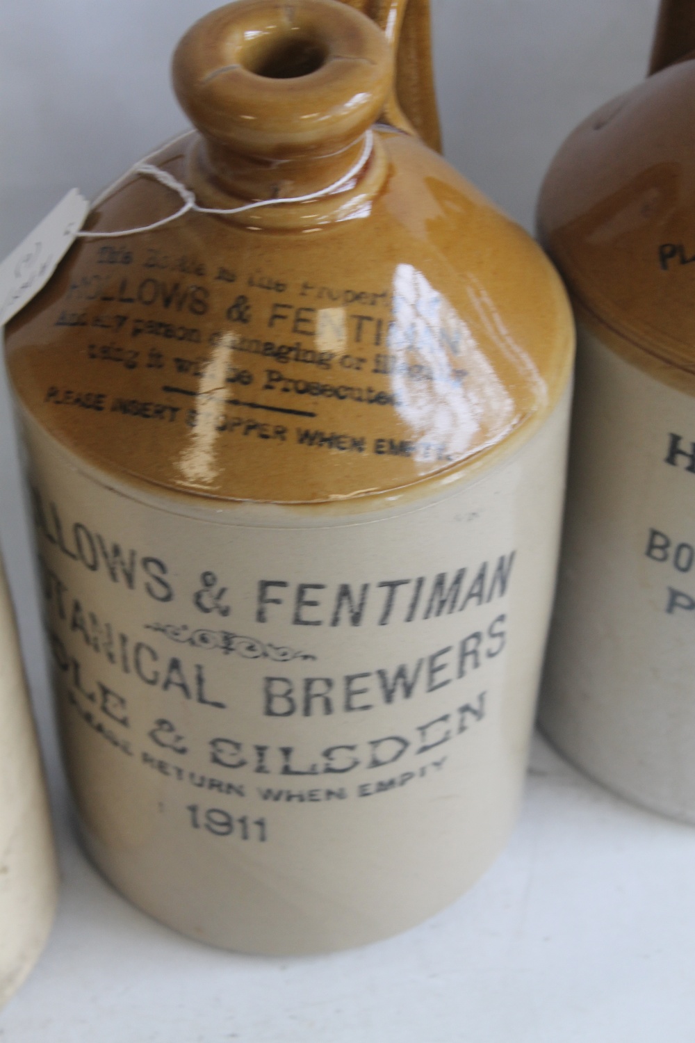 SIX STONEWARE FLAGONS to include 'Hollows & Fentiman Botanical Brewers ...