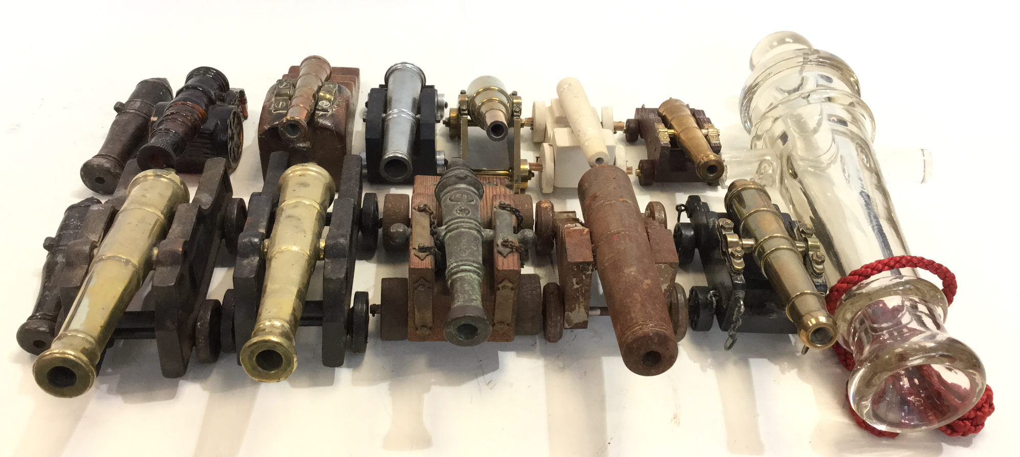 A collection of approx 20 model Ship's cannons in brass or bronze. Also ...