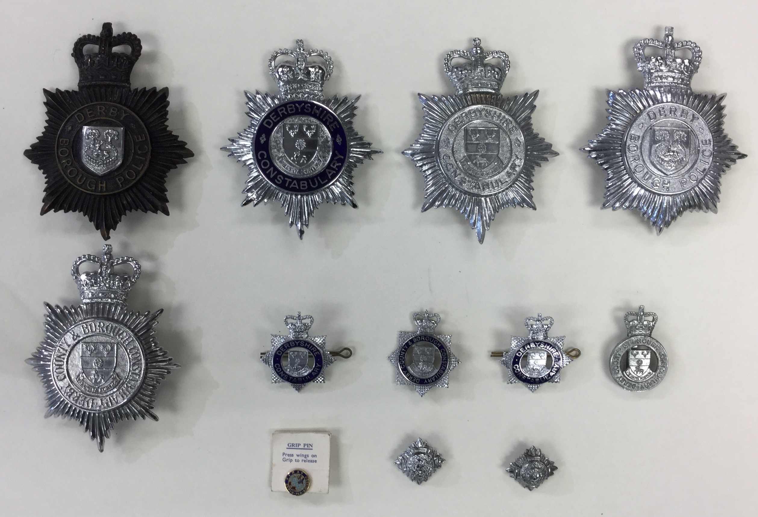 A collection of Derbyshire Police Force Queens crown cap badges ...
