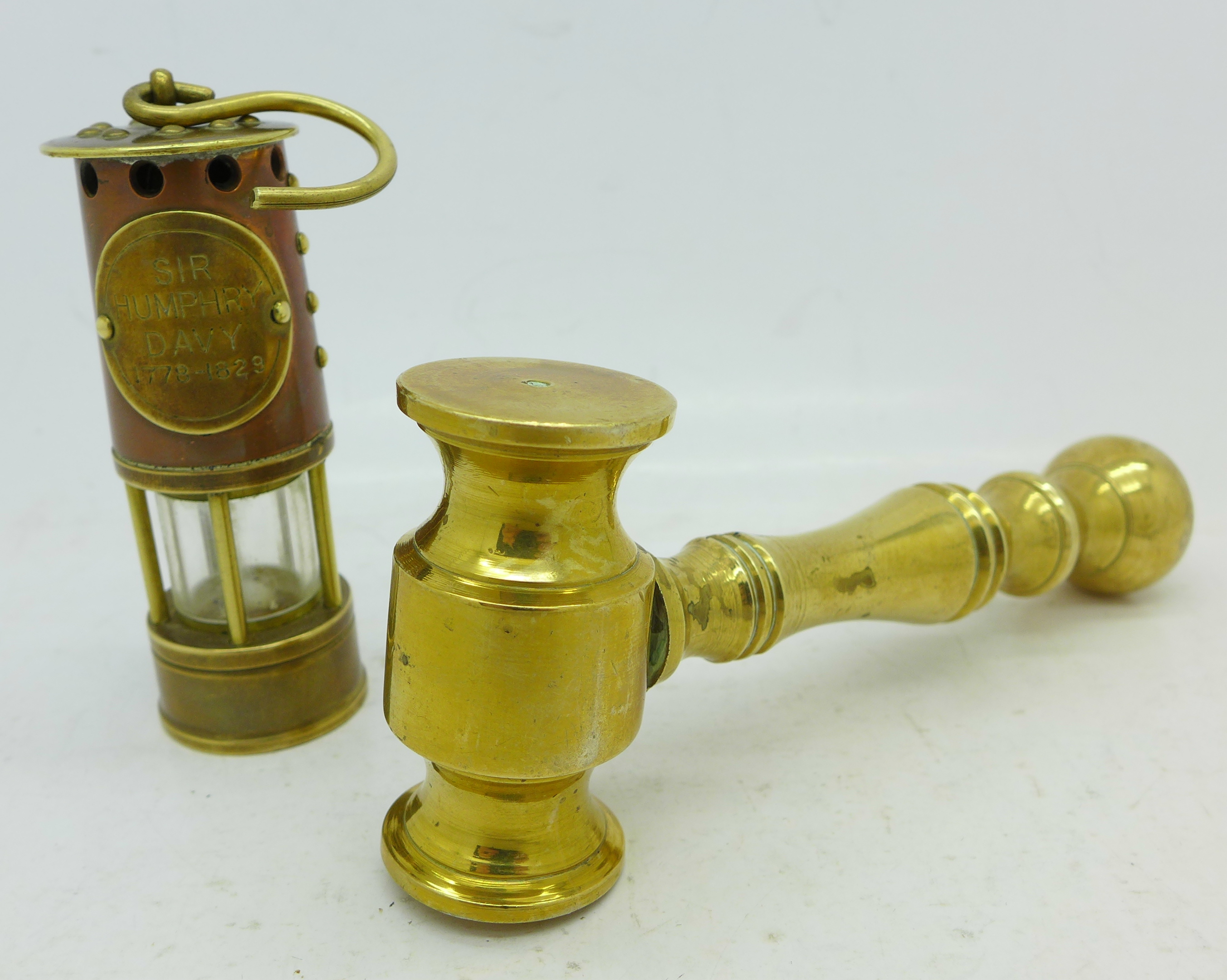 A small brass gavel and a small commemorative miner's lamp, marked Sir ...
