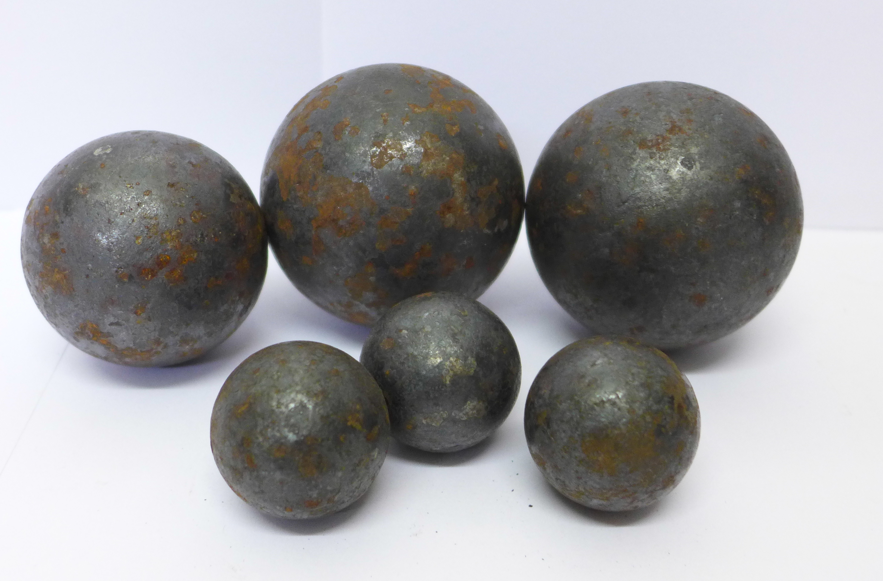 Three cannon balls and three large musket balls