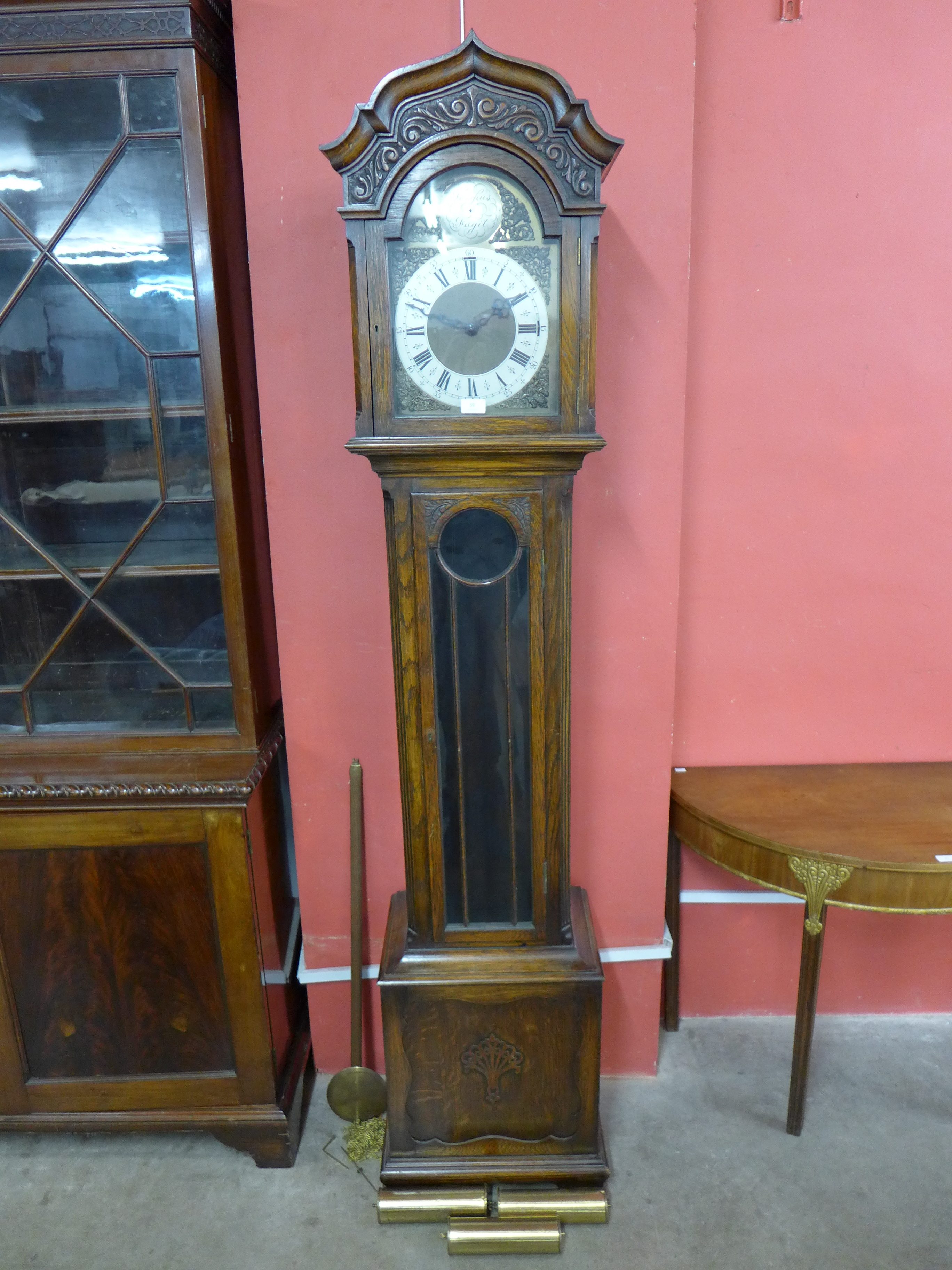 An early 20th Century oak longcase clock, with three weight chain ...