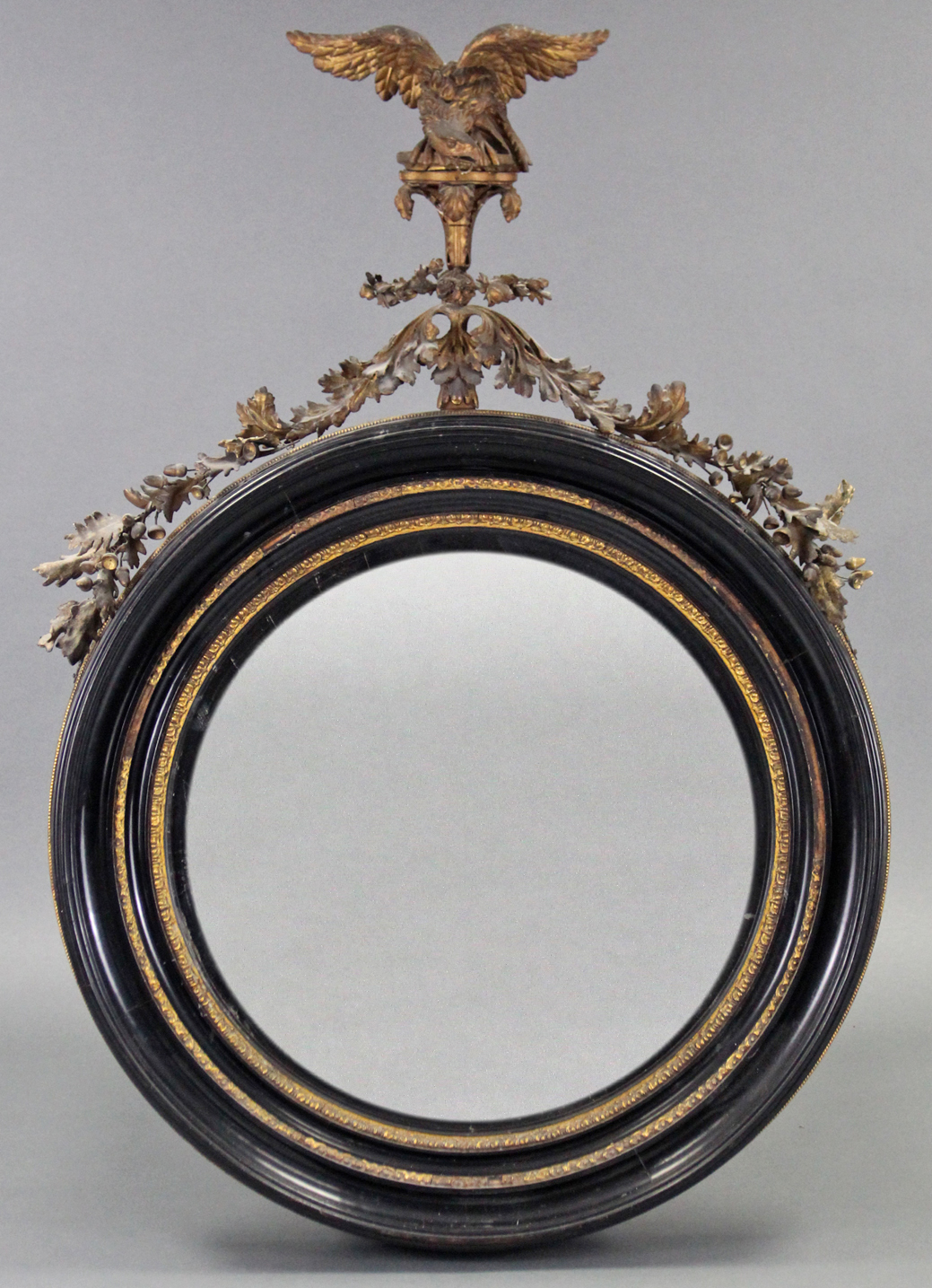 A REGENCY EBONISED & GILT-GESSO FRAME LARGE CONVEX WALL MIRROR, with ...
