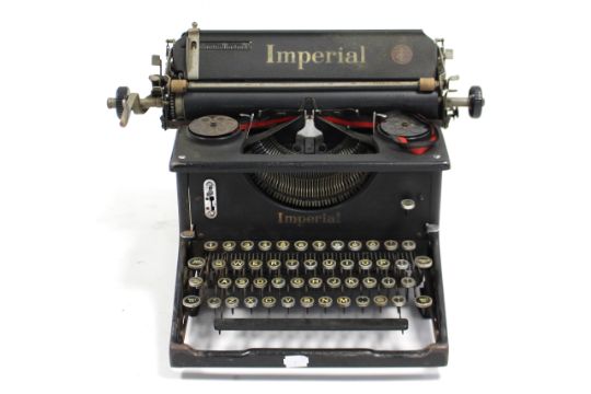 A mid-20th century Friden calculating machine; an Imperial typewriter ...