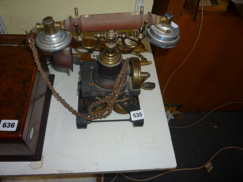 An antique telephone with winding handle, the earpiece numbered 28 [C ...