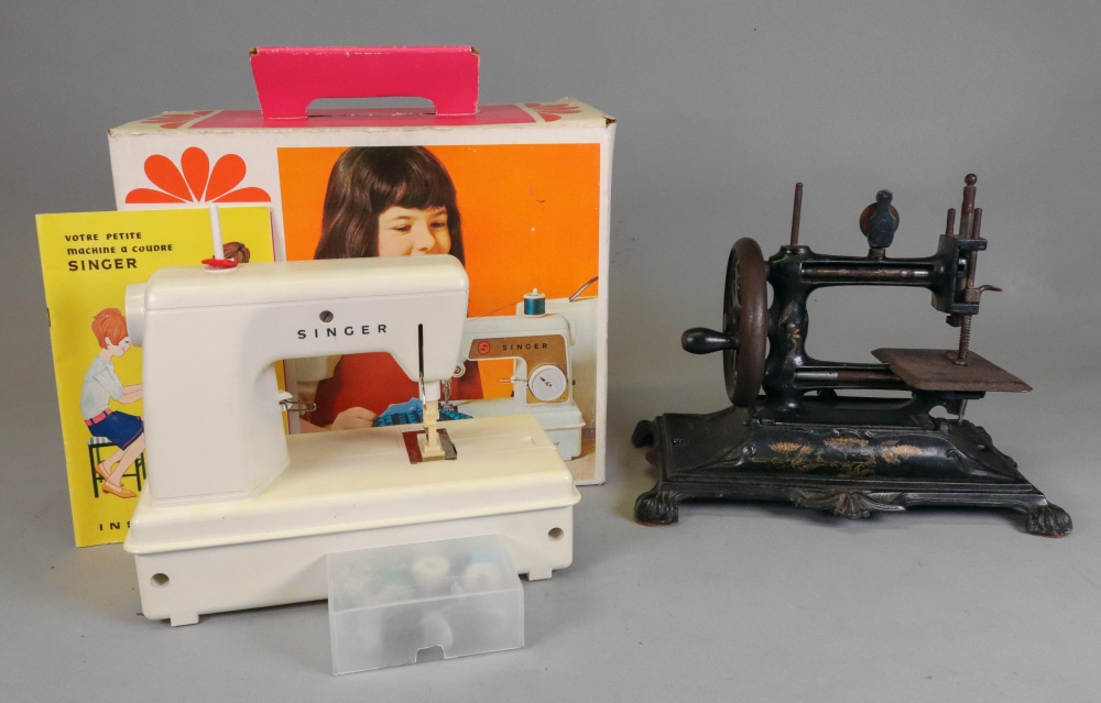 A child's battery operated Singer sewing machine, circa 1960's, boxed ...
