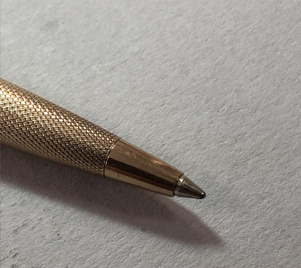 Parker - A 9ct gold retractable ballpoint pen, decorated all over with ...