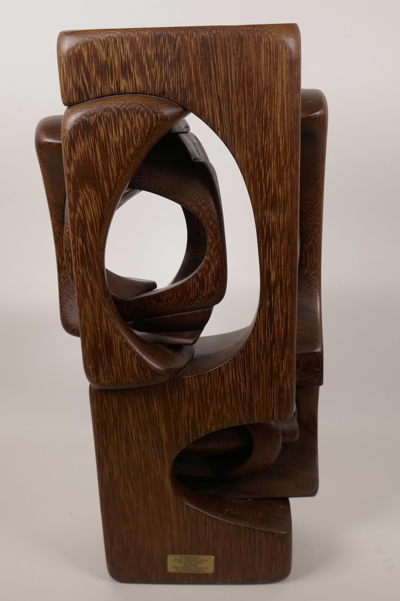A carved hardwood sculpture in the manner of Brian Wilsher, unsigned ...