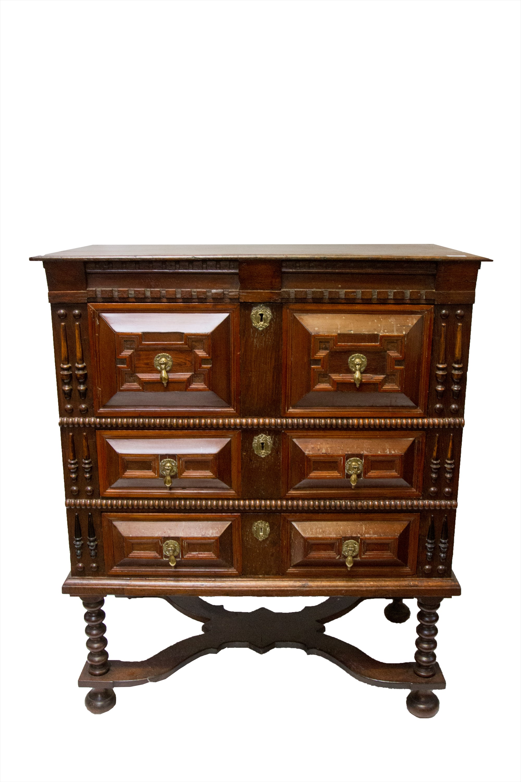 A 17th century oak chest on stand, with three long drawers on bobbin ...