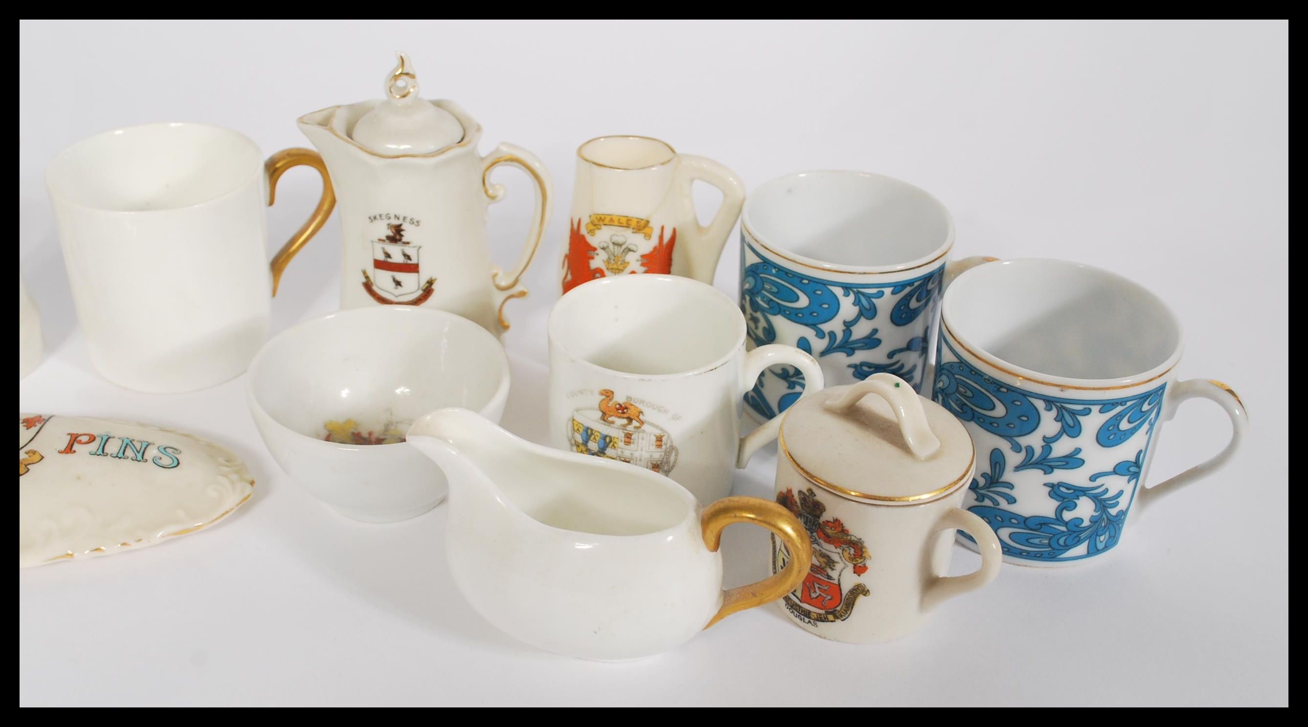 A collection of Goss souvenir ware ceramics to include teapot, mugs ...