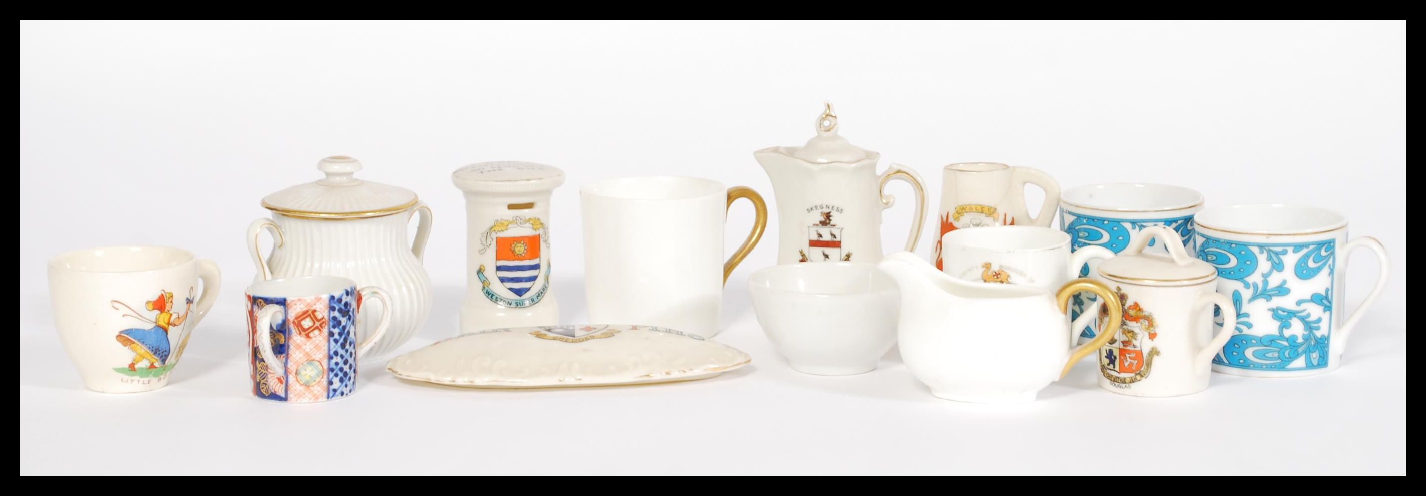 A collection of Goss souvenir ware ceramics to include teapot, mugs ...