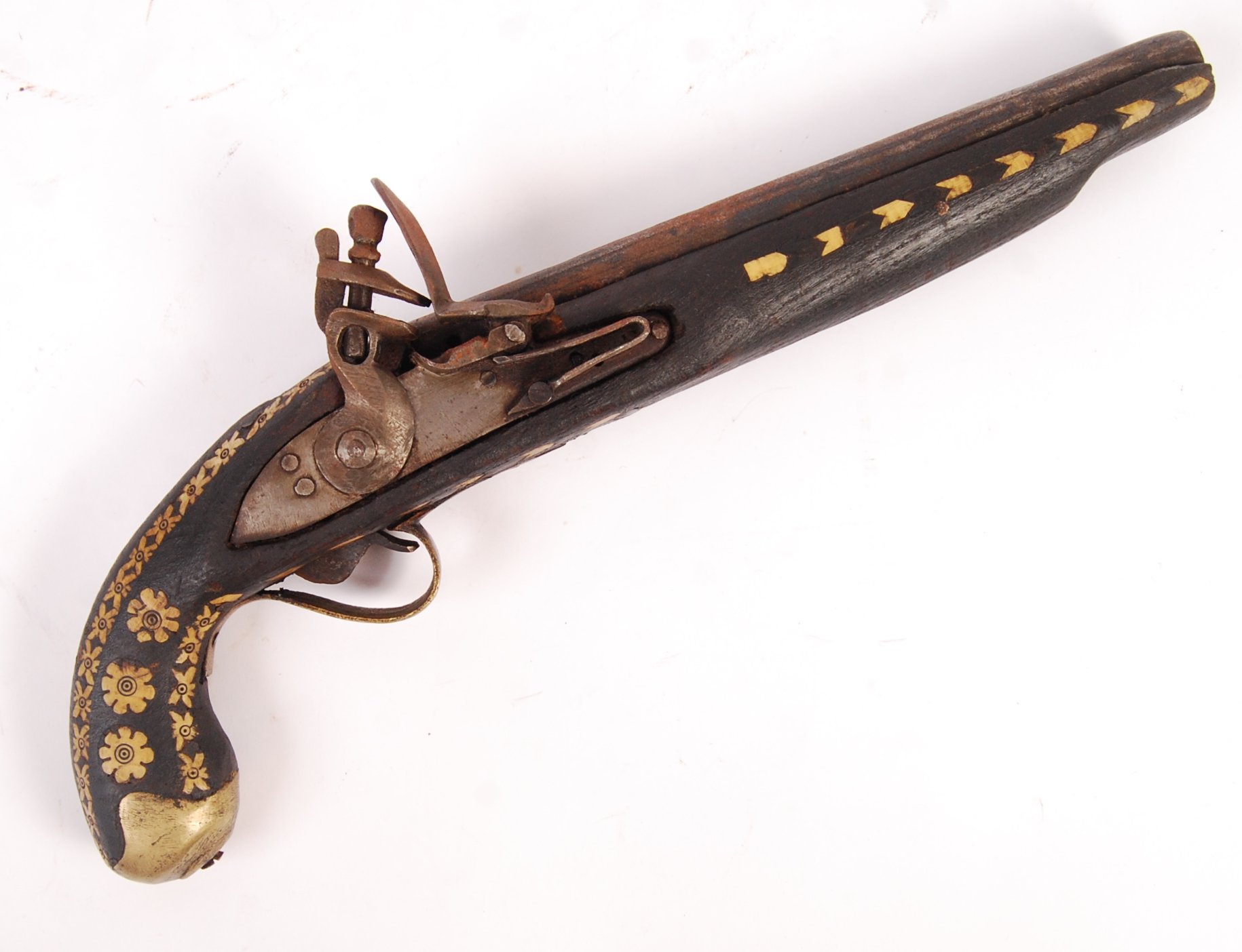 A 19th Century Indian flintlock pistol having bone inlay and floral ...