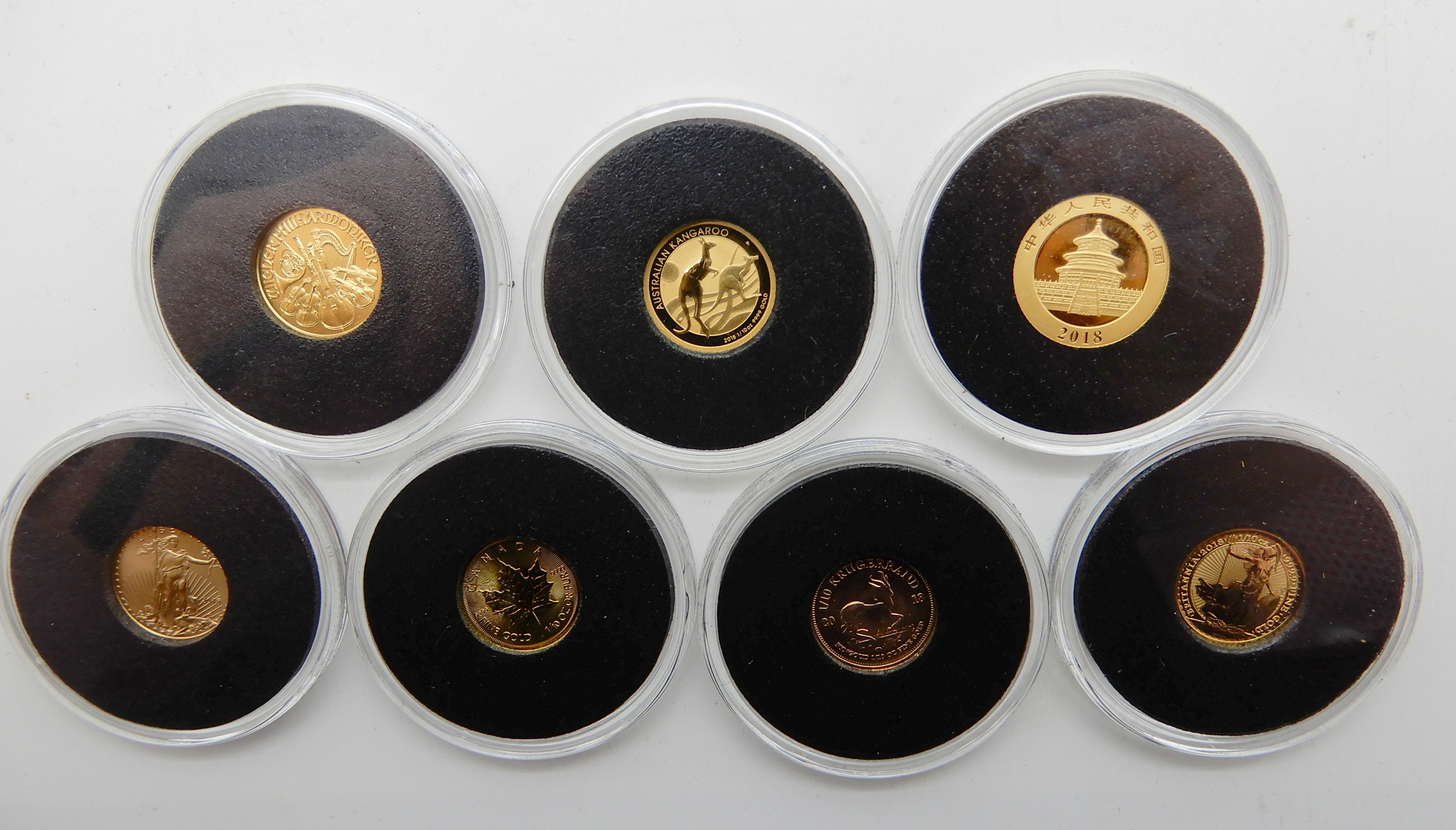 A cased set of The Seven Wonders of the Gold Coin World - seven gold ...