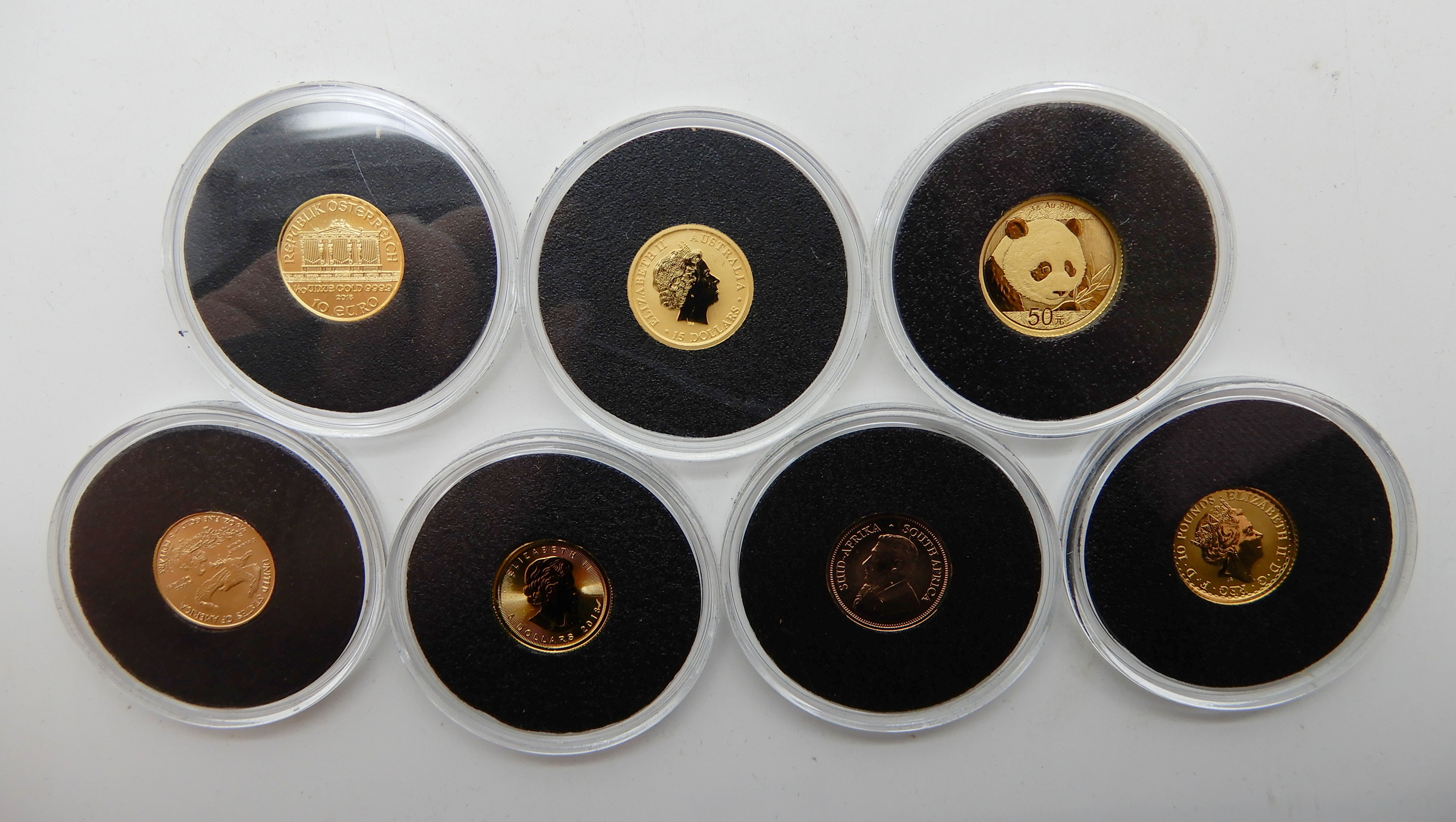 A cased set of The Seven Wonders of the Gold Coin World - seven gold ...