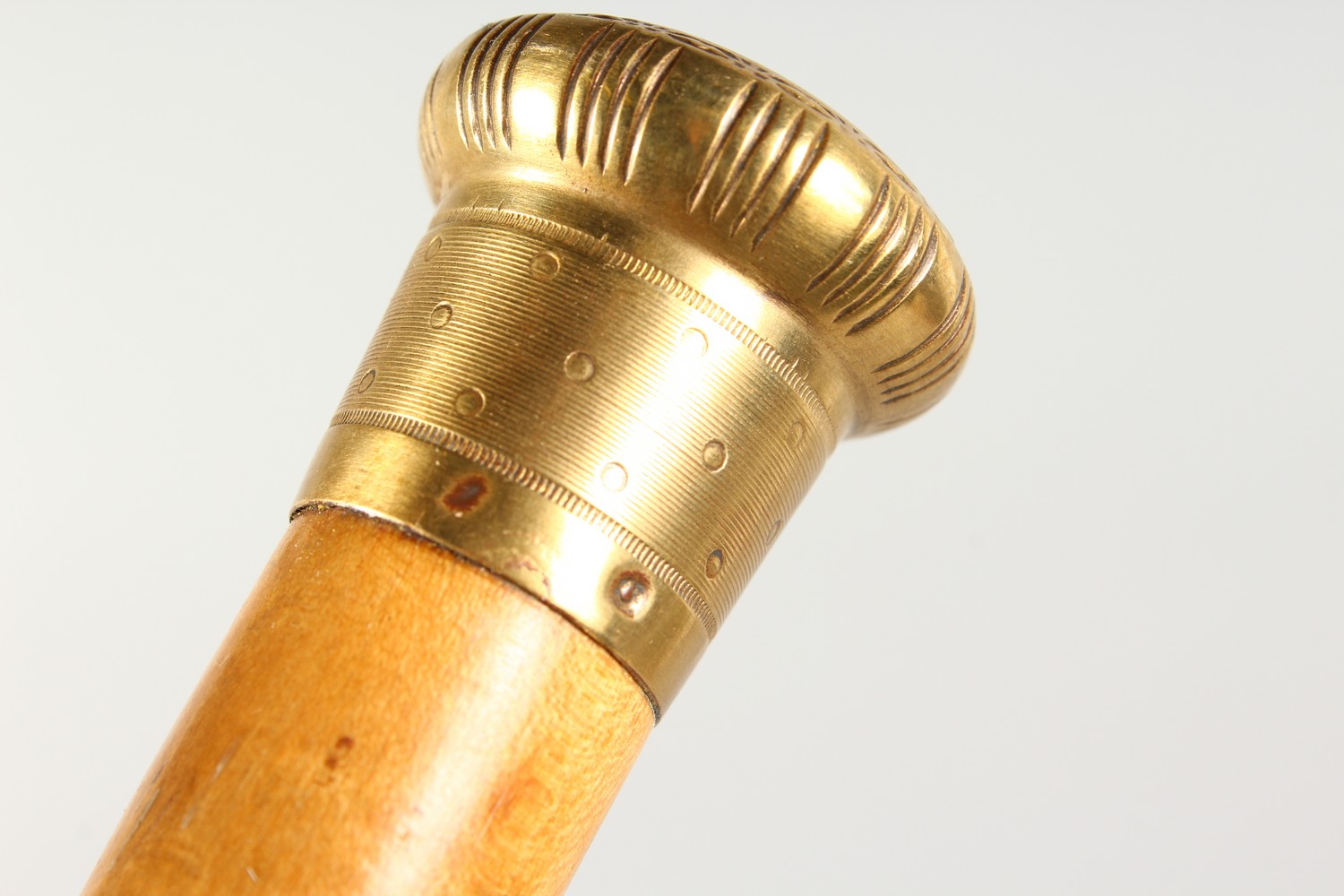 A CONTINENTAL GOLD TOP BURR WOOD WALKING STICK. 42ins long.