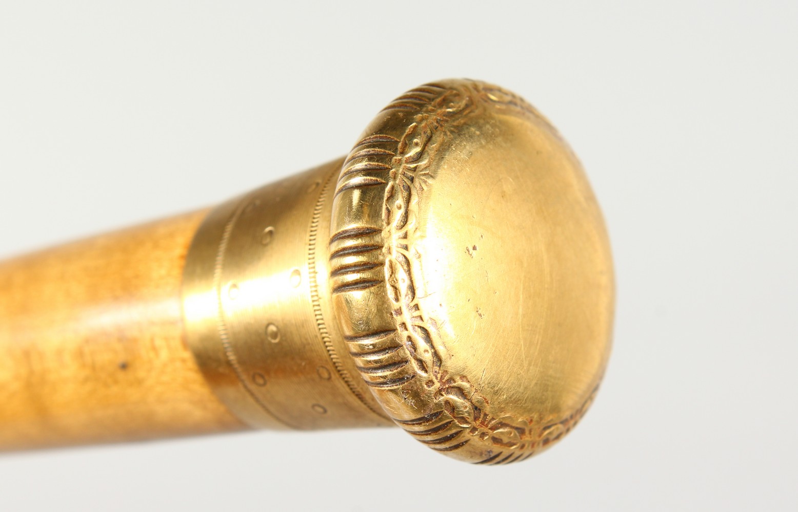 A CONTINENTAL GOLD TOP BURR WOOD WALKING STICK. 42ins long.
