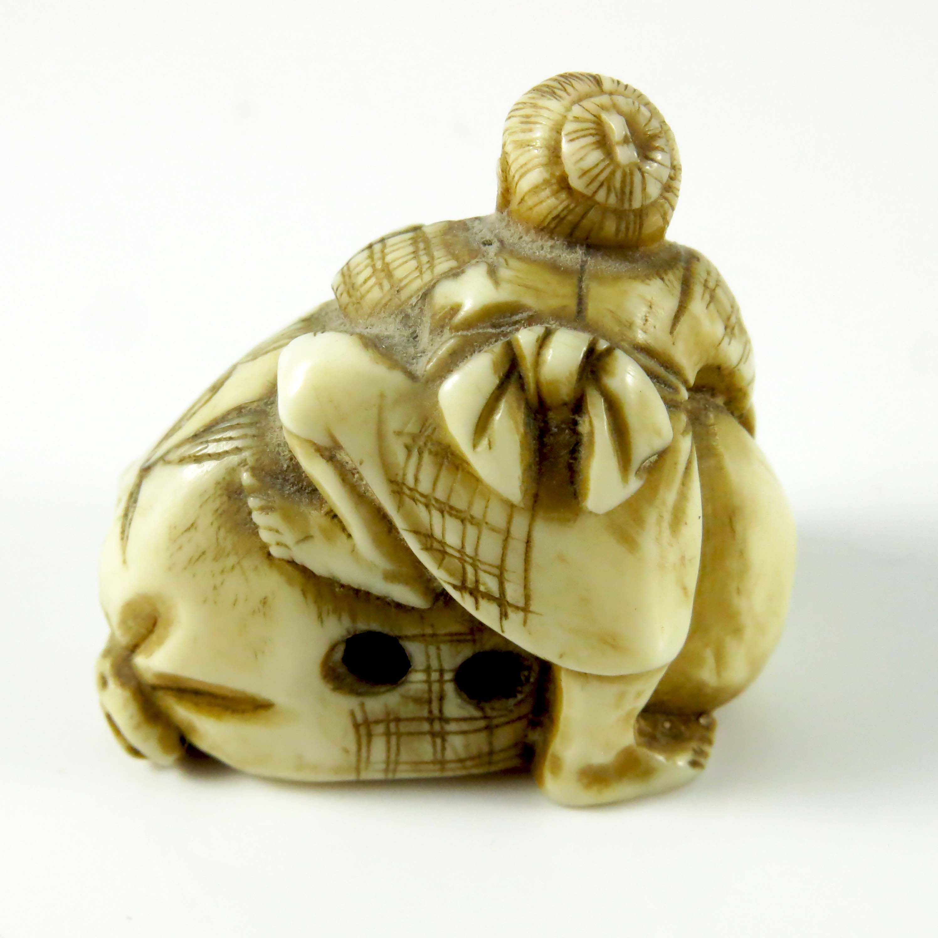 JAPANESE MEIJI PERIOD NETSUKE DEPICTING A MAN CLIMBING ONTO A SACK ...