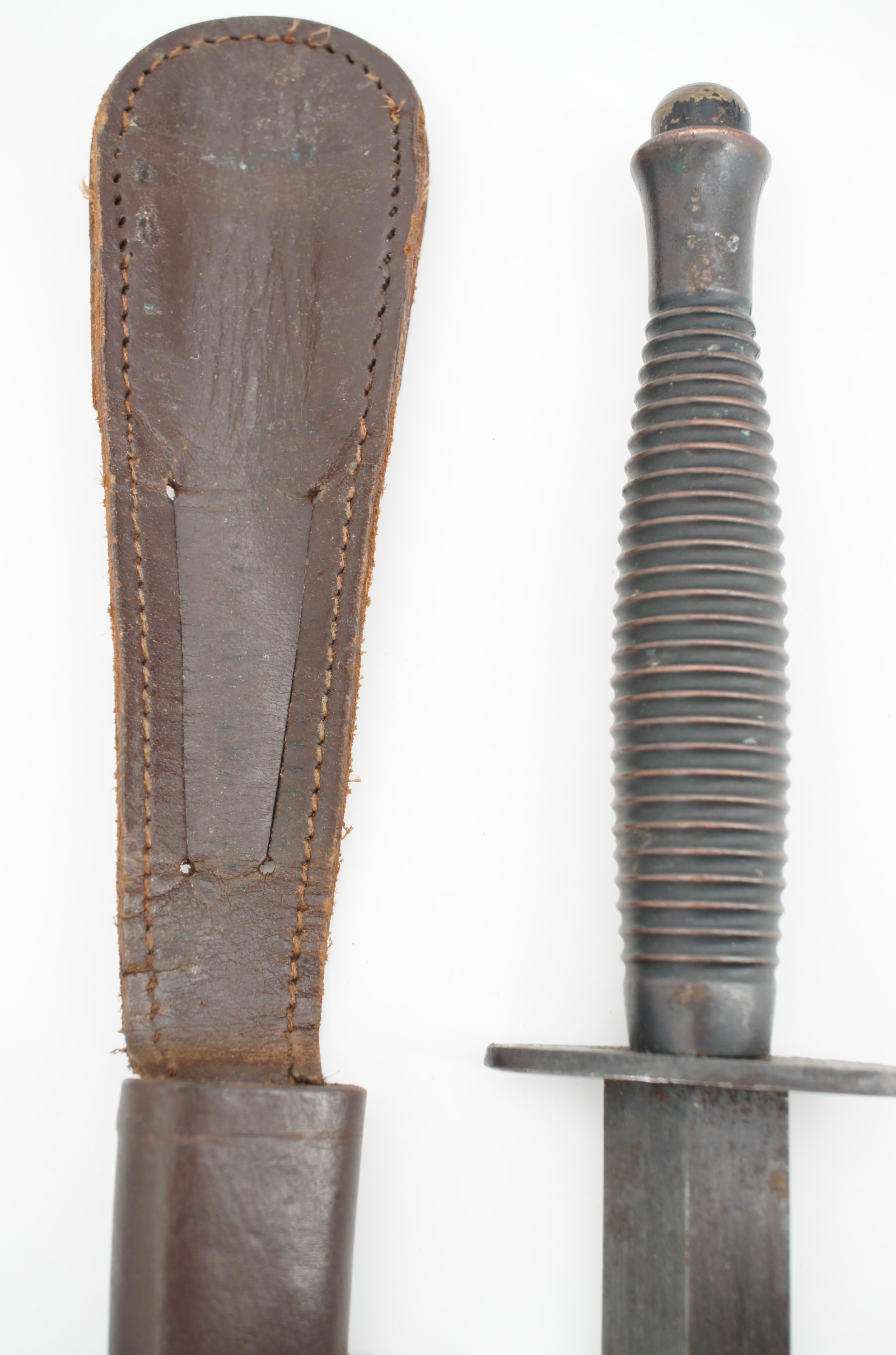 A Fairbairn Sykes / FS third pattern fighting knife, the grip bearing ...