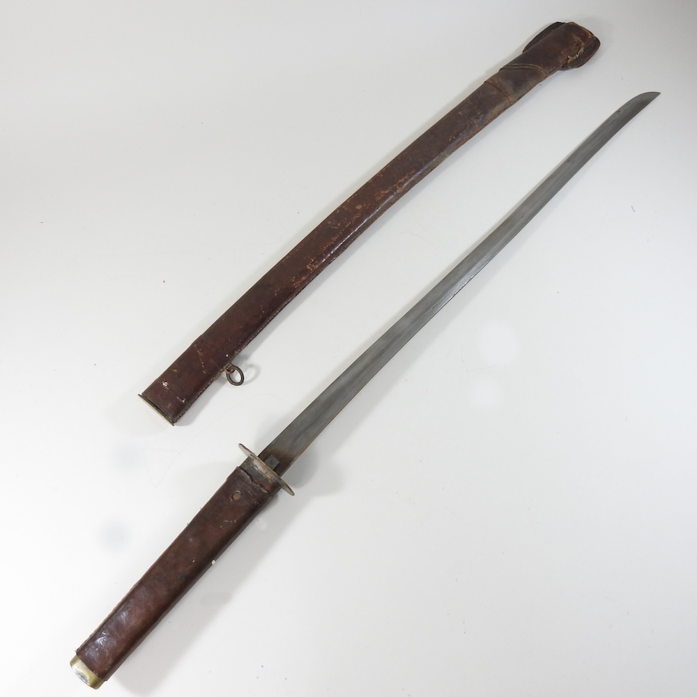 A World War II Japanese sword, in a leather scabbard, 106cm