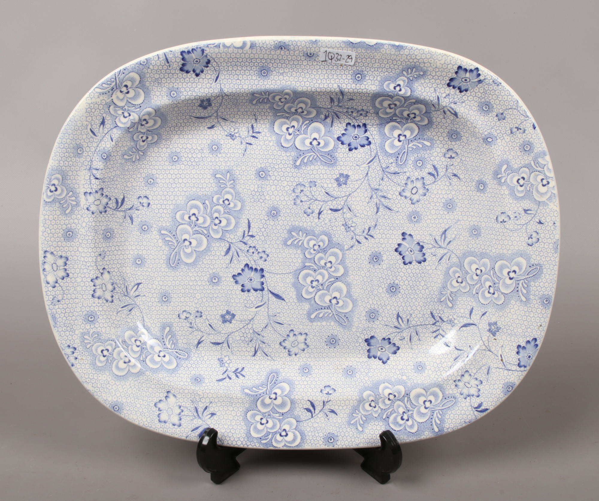 A Twigg Newhall pottery blue and white meat plate decorated with flower ...