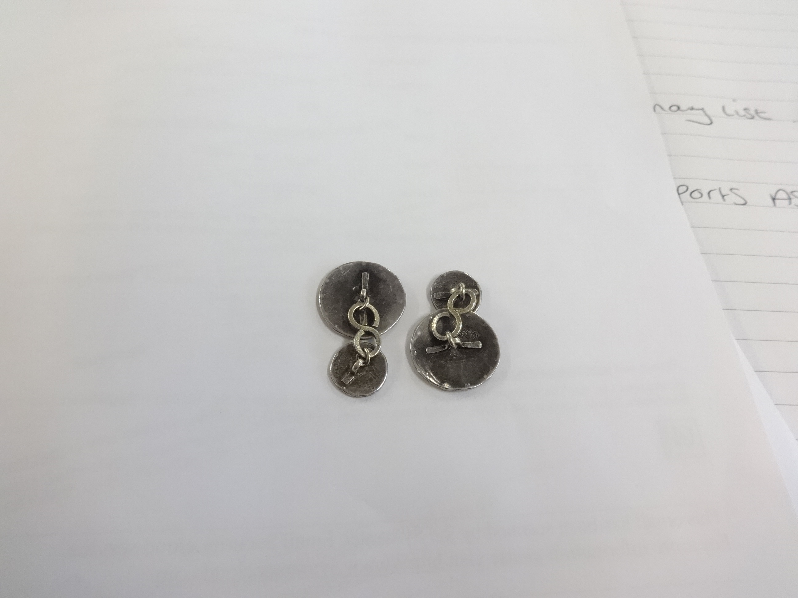 A pair of arts and crafts style enamel cufflinks each decorated with a ...