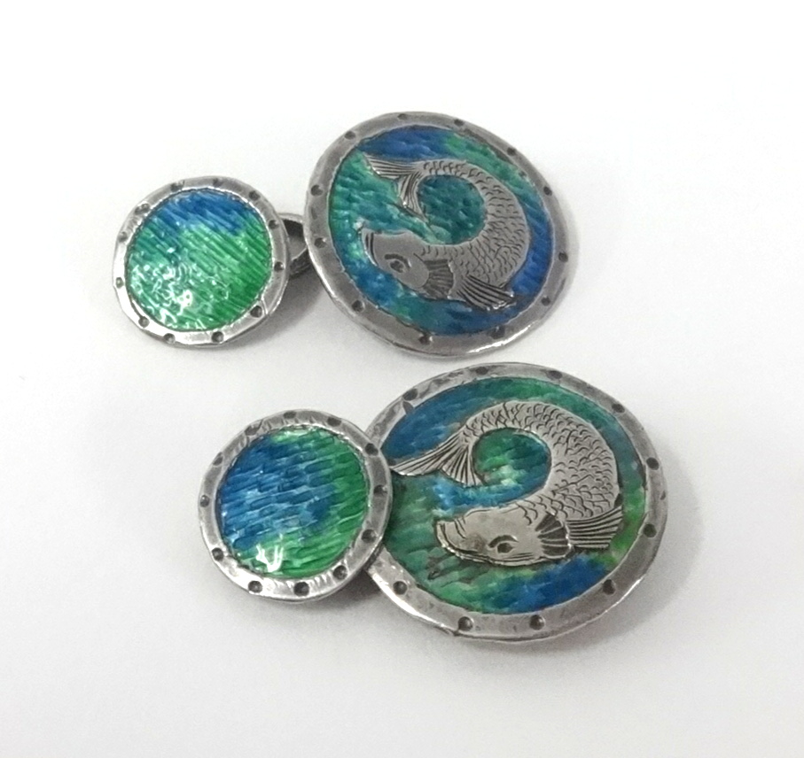 A pair of arts and crafts style enamel cufflinks each decorated with a ...