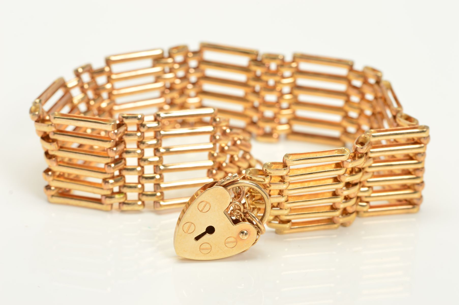 A 9CT GOLD GATE BRACELET, with heart padlock clasp and safety chain ...