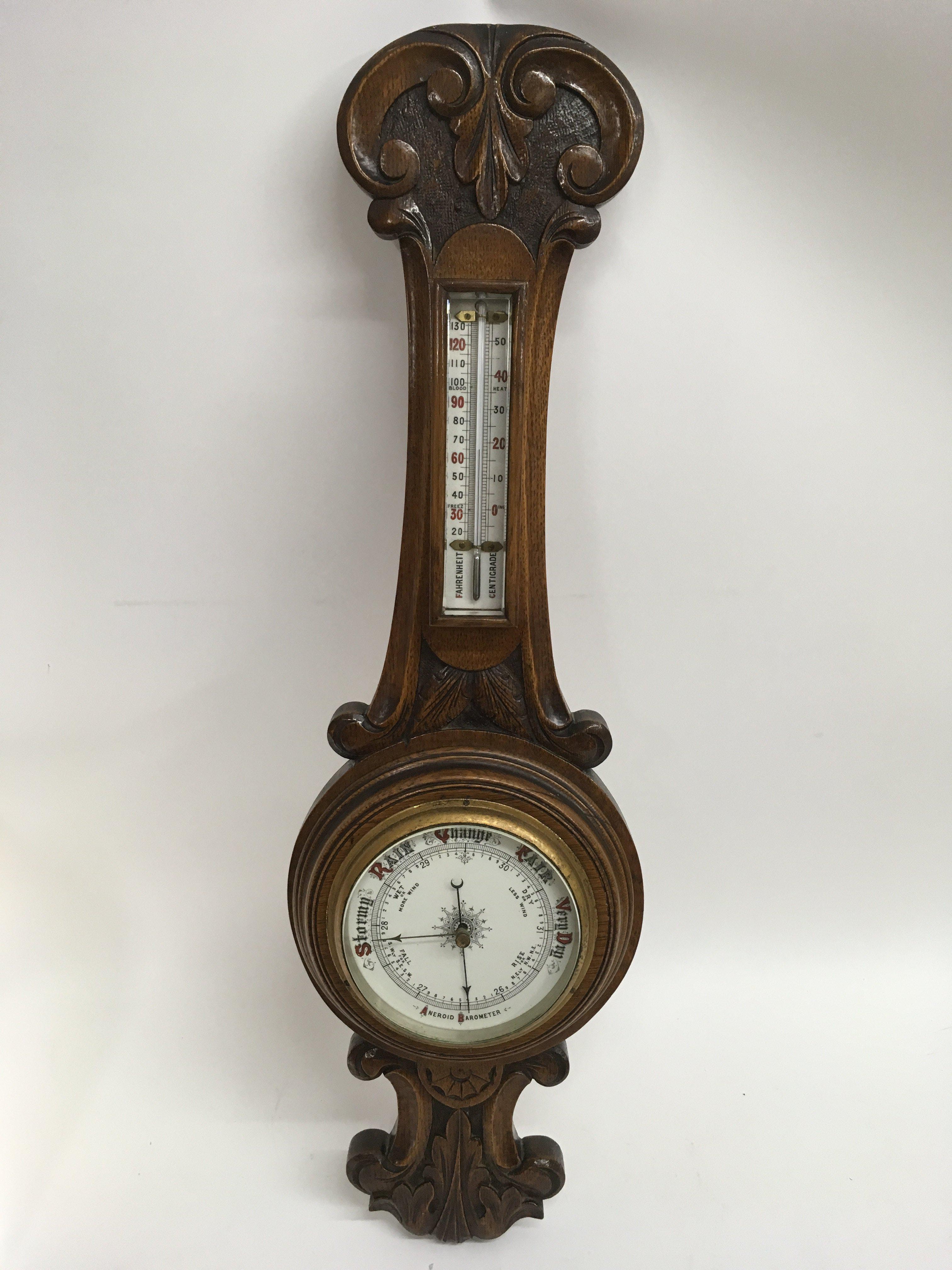 A carved oak barometer